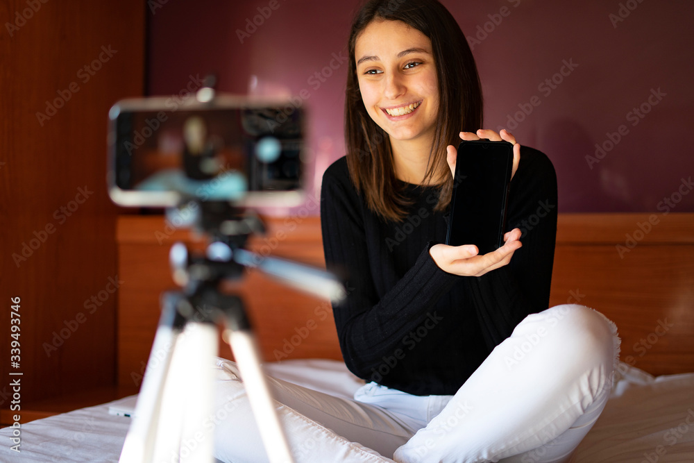 Vlogger and influencer doing review of a mobile. Stock Photo | Adobe Stock