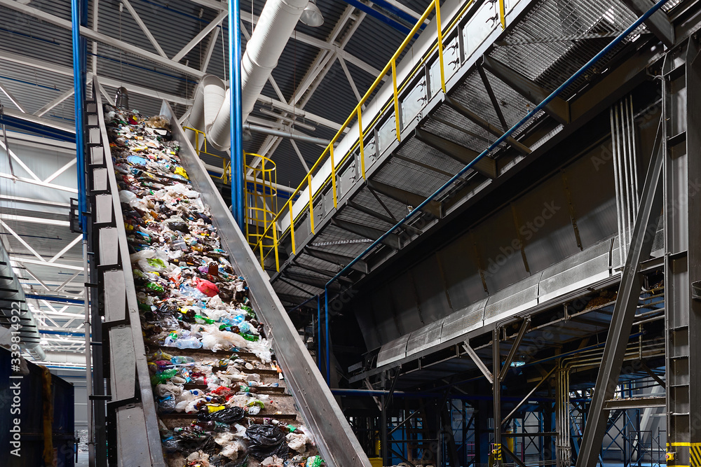 Conveyor belt transports garbage inside drum filter or rotating ...
