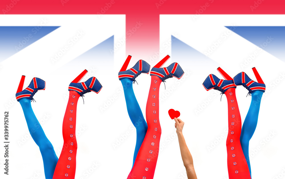 Three women's legs are stretched out high in a vertical form in front ...