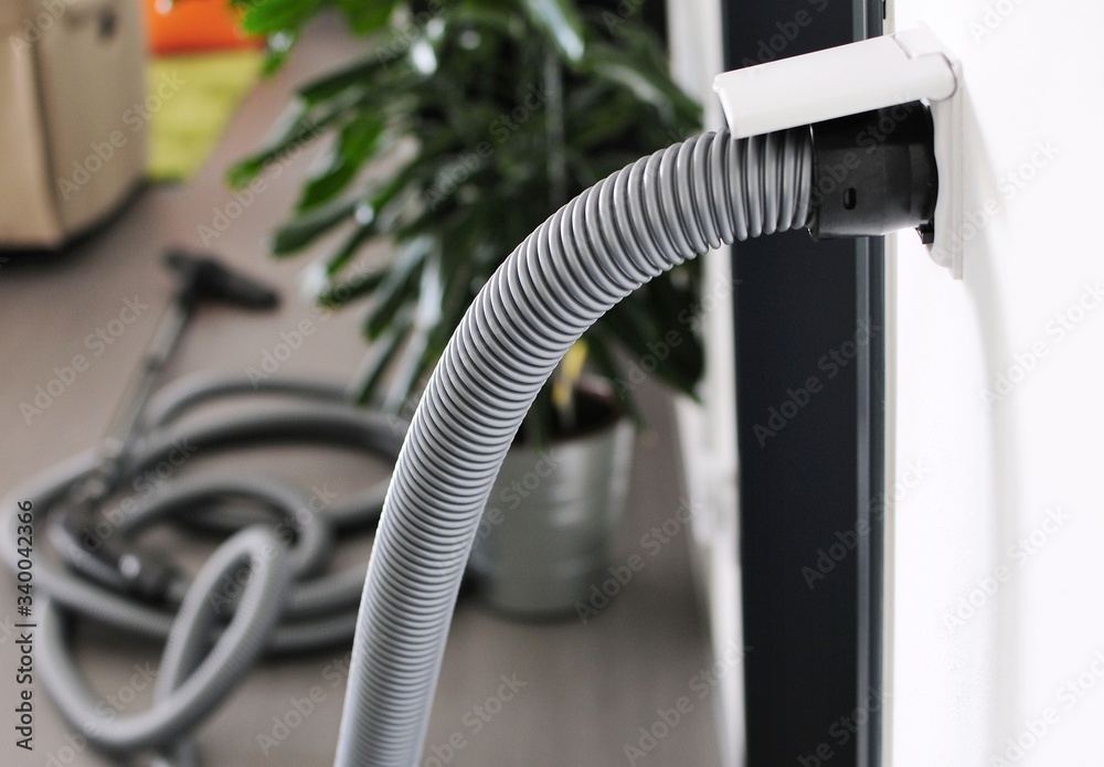 Central vacuum cleaner hose plugged in to wall inlet Stock Photo ...