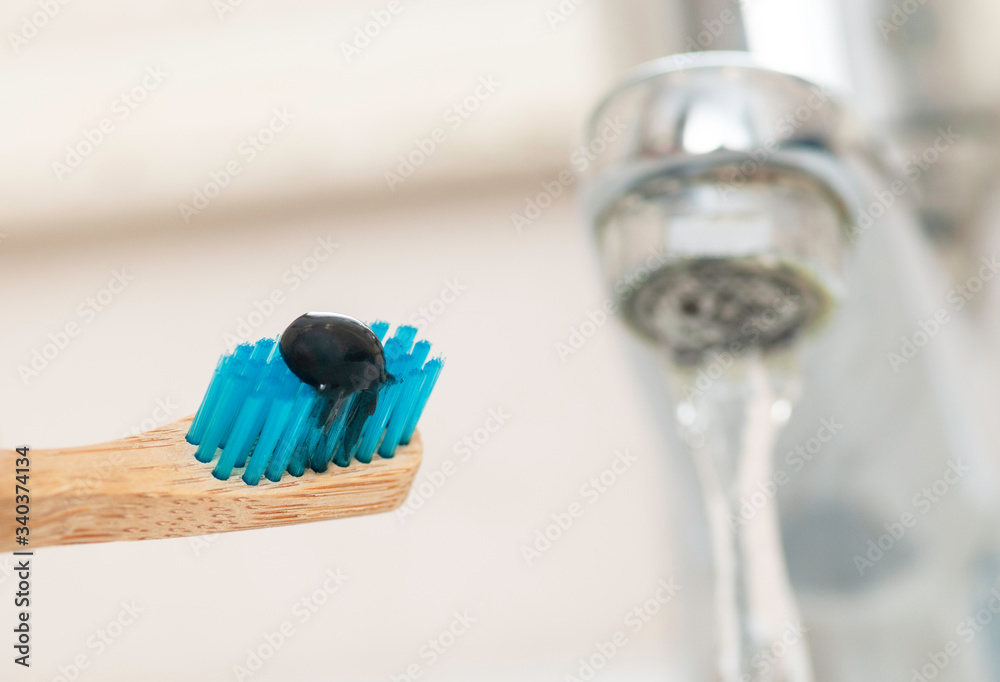 Bamboo toothbrush with activated carbon toothpaste and the recommended ...