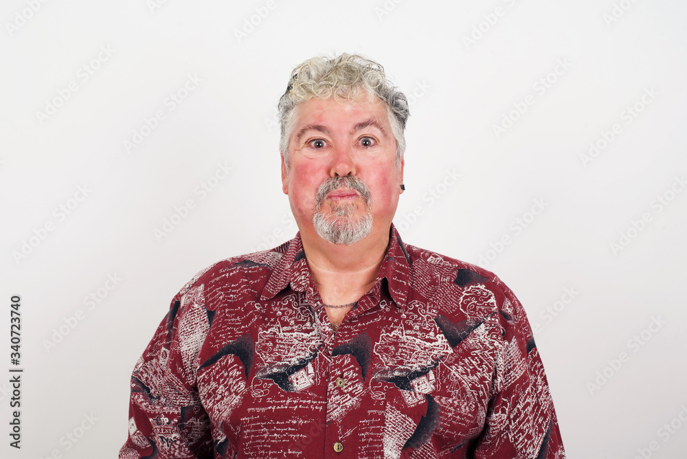 Handsome young man puffing cheeks with funny face. Mouth inflated with ...