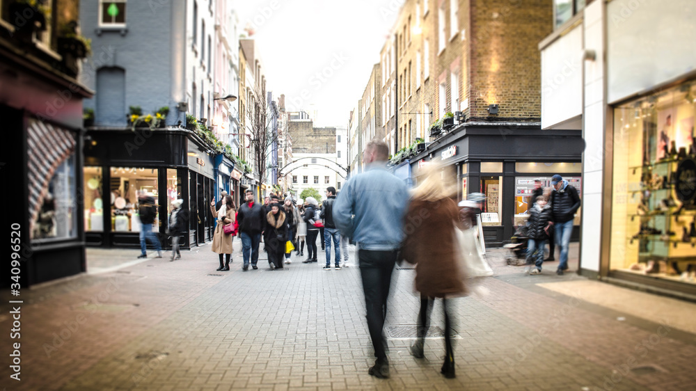 Motion blurred high street shoppers Stock Photo | Adobe Stock