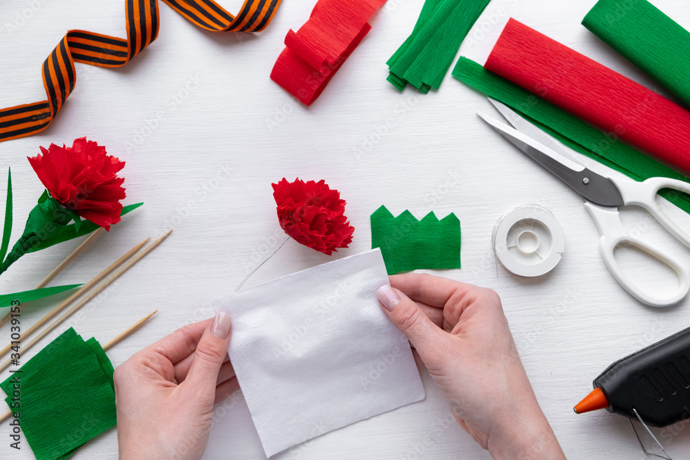 How to make carnation flower at home. Hands making red carnation to ...