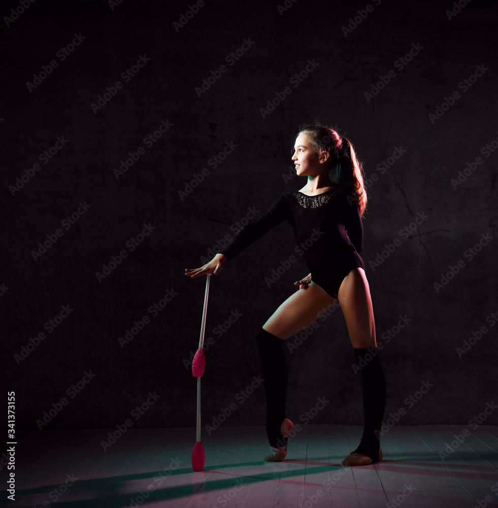 Young smiling girl gymnast in black sport body and uppers standing ...