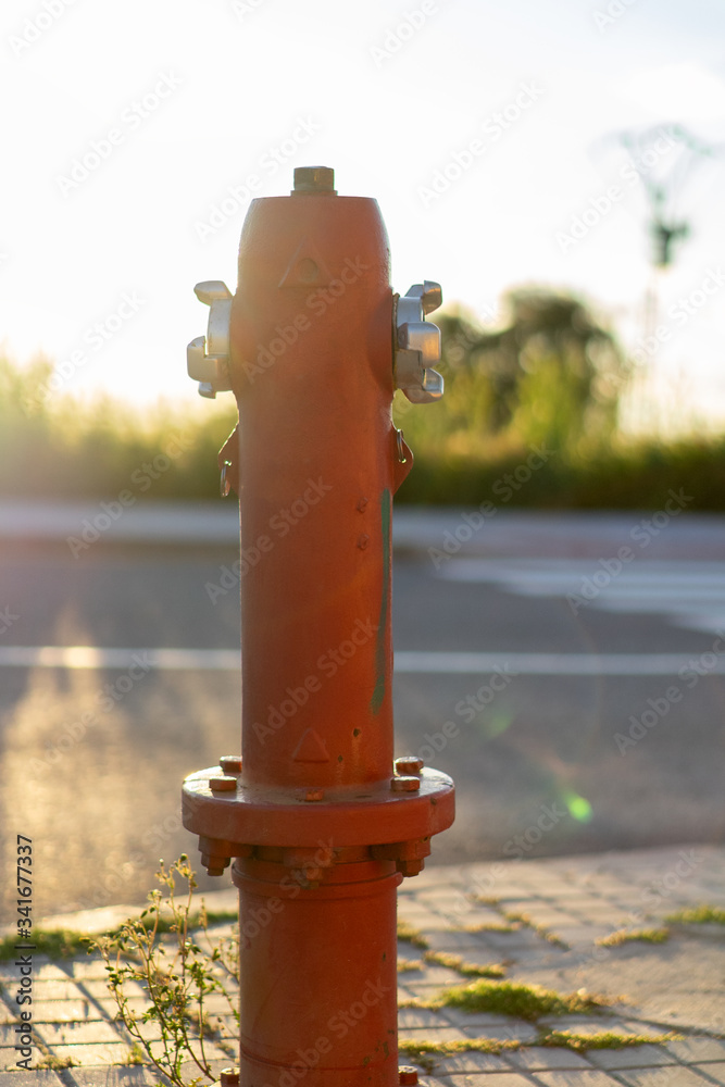 Old red fire hydrant at sunset. Fire hidrant for emergency fire access ...