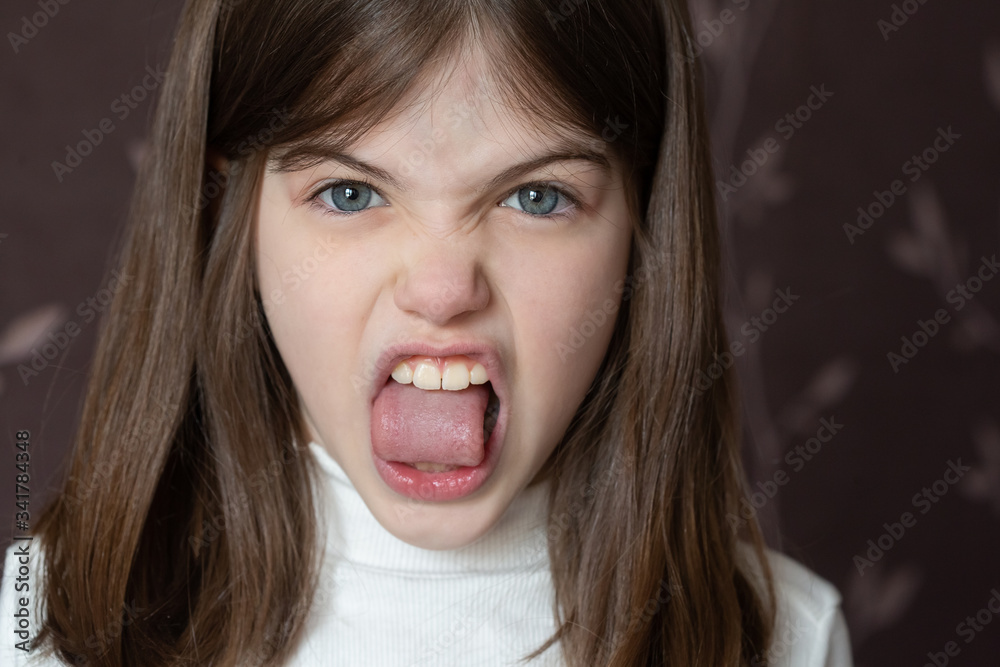 little angry girl shows tongue Stock Photo | Adobe Stock
