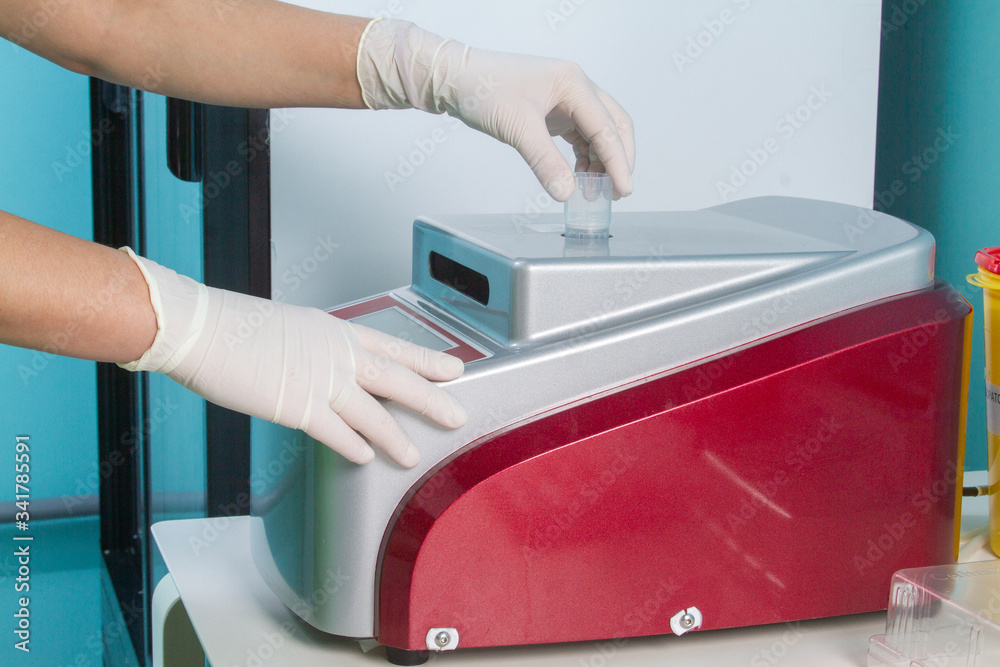 Histology test lab in hospital. Hands in gloves, tech loads slide ...
