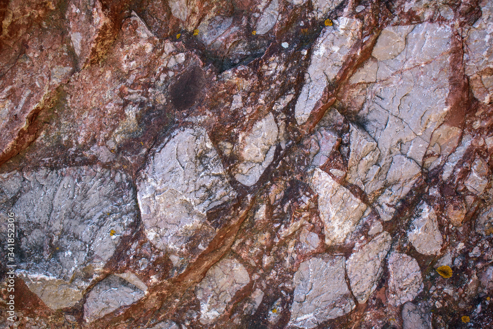 Rocky wall for the backdrop. Rough surface with inclusions and ...