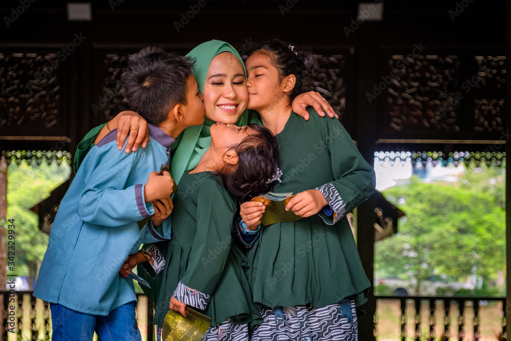 Happy children with an envelope of pocket money or raya angpao are ...