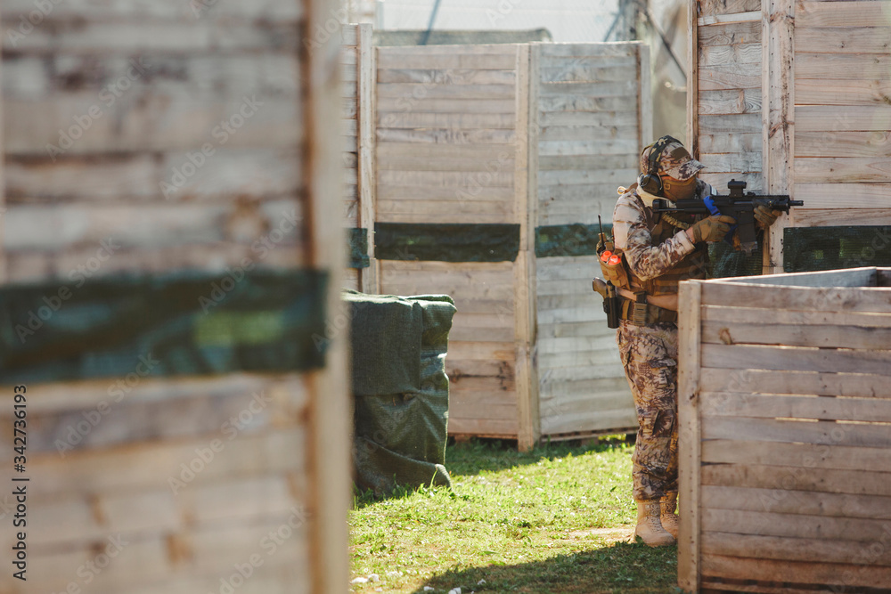 the airsoft player pointing his gun while taking cover Stock Photo ...
