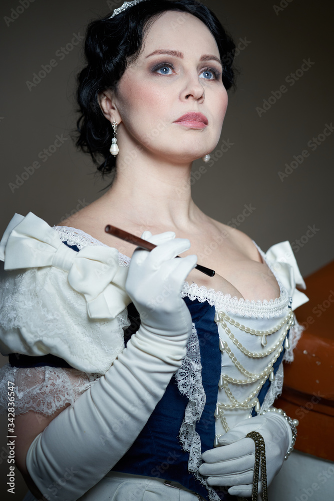Portrait of a beautiful girl in a romantic dress, in a retro style.With ...