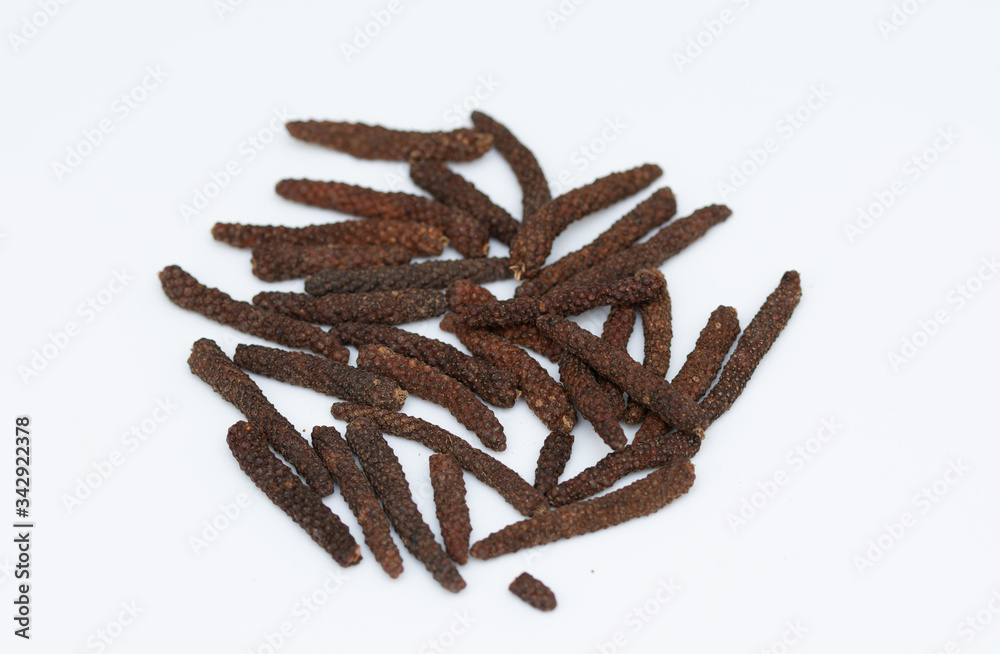 Long pepper or Piper longum on white background Long black pepper (Also ...