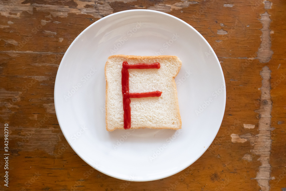bread of breakfast is written F by ketchup on write plate. A to Z and ...