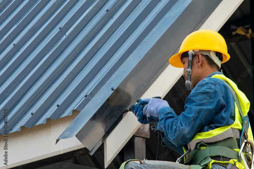 Technician working on roof structure on construction site,Construction ...