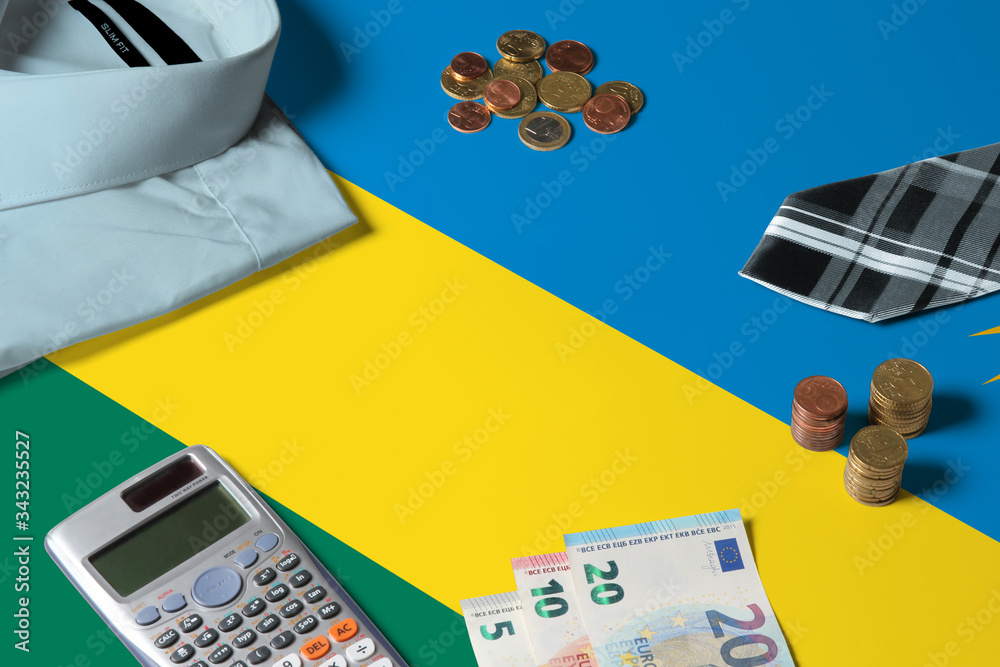 Rwanda flag on minimal money concept table. Coins and financial objects ...