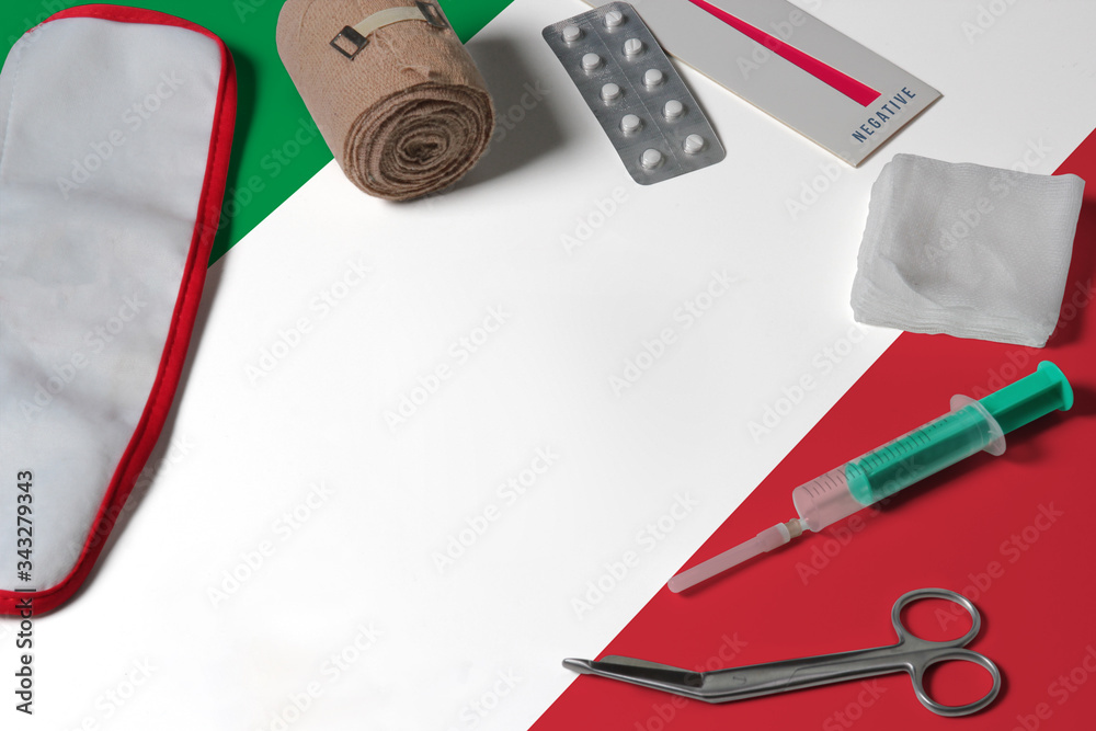 Italy flag with first aid medical kit on wooden table background ...