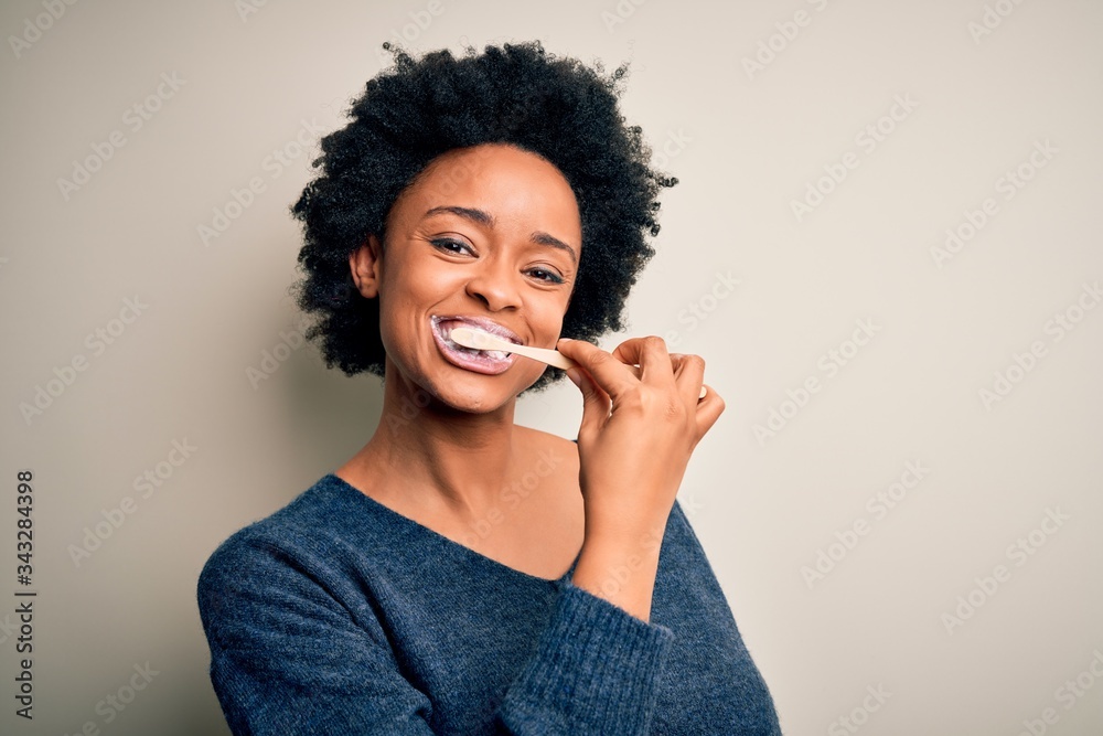 African american woman brushing her teeth using tooth brush and oral ...
