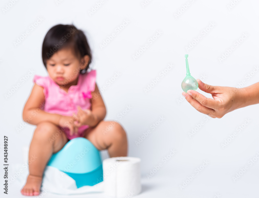 Asian little cute baby child girl training to sitting on blue chamber ...
