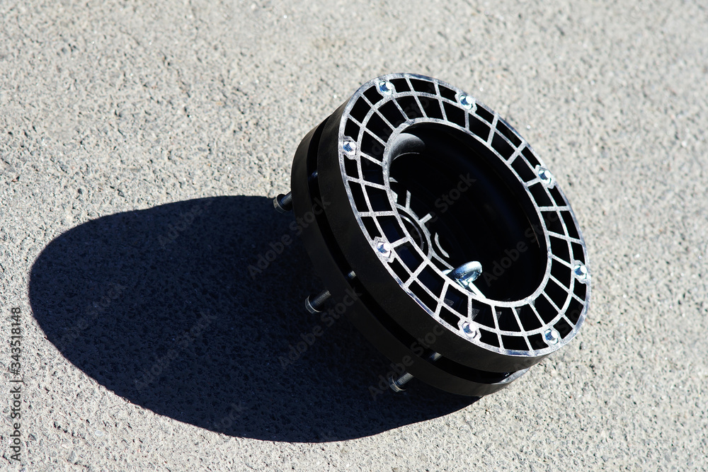 Borehole head on asphalt background. Head for a borehole black. The ...