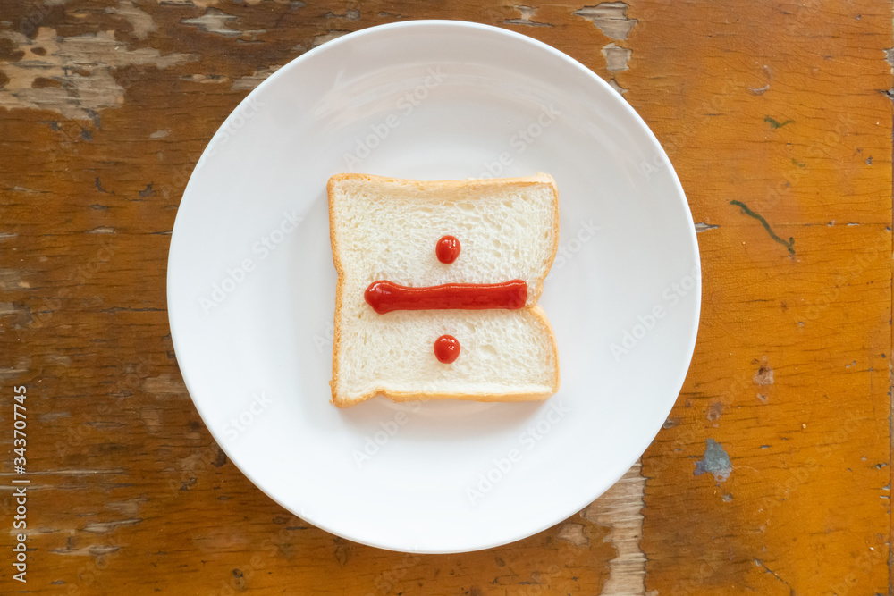 Stock-Foto „bread of breakfast is written Divide sign by ketchup on ...