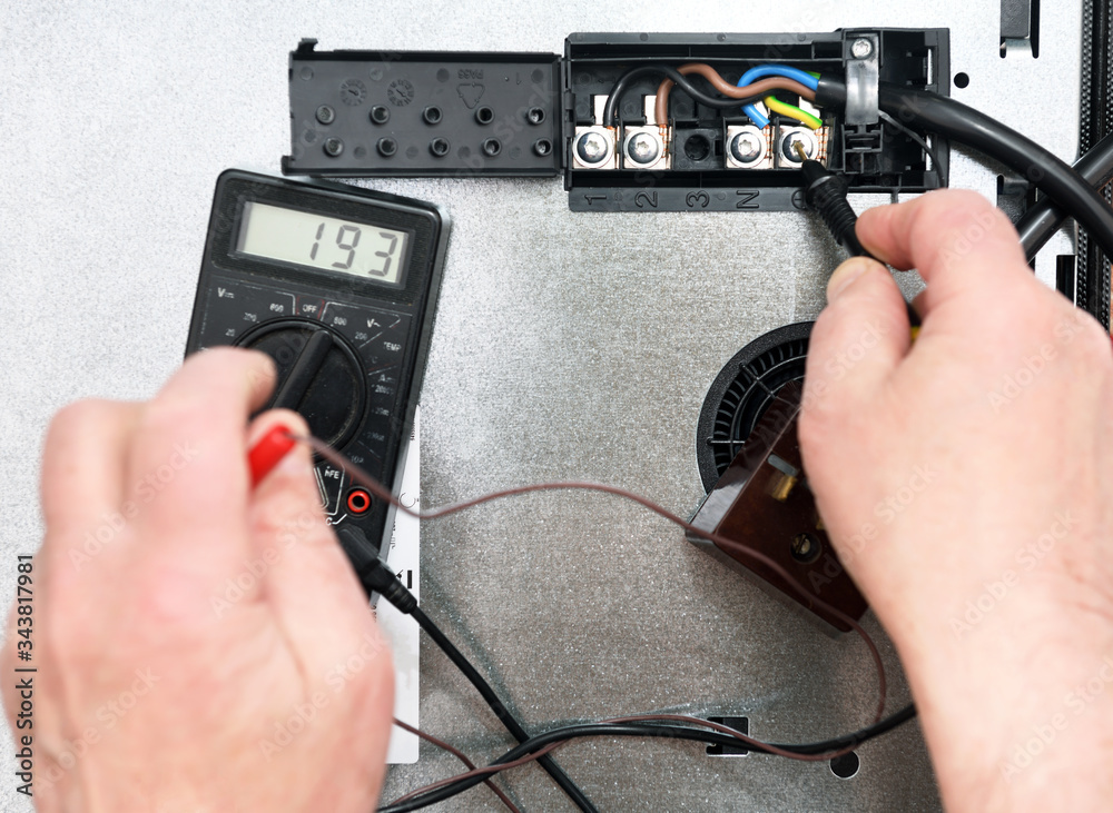 A professional electrician checks the connection quality, contact ...