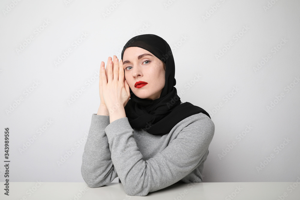 Young Muslim woman in hijab with red lips isolated on white background ...