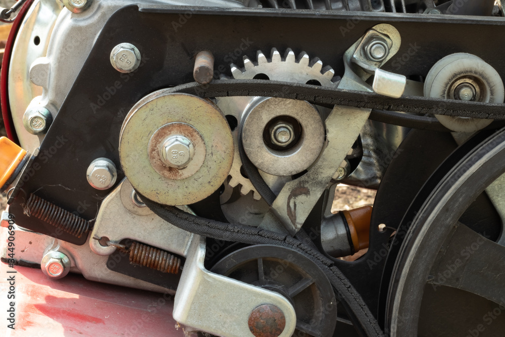 Hand tractor in the garden. A cultivator with a plow makes a furrow in ...