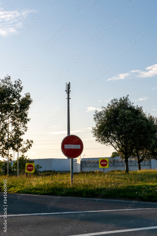 pylon, GSM 5G transmitter tower on the background of three road signs ...