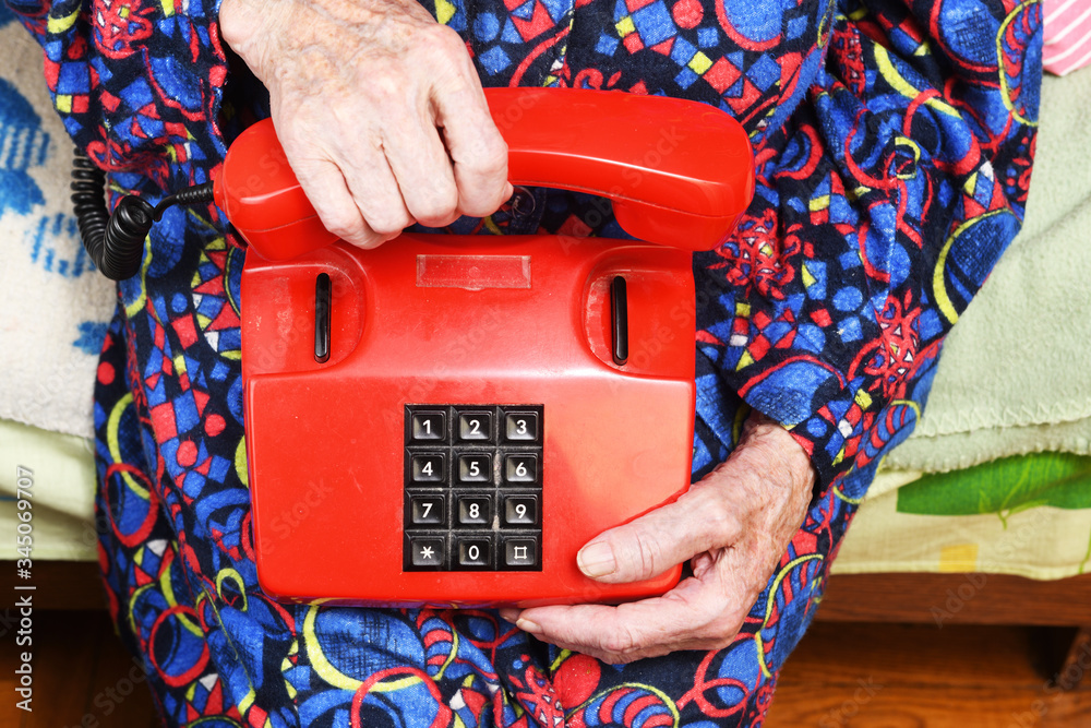 In her hands an old grandmother of 90 years holds in her hand a red old ...