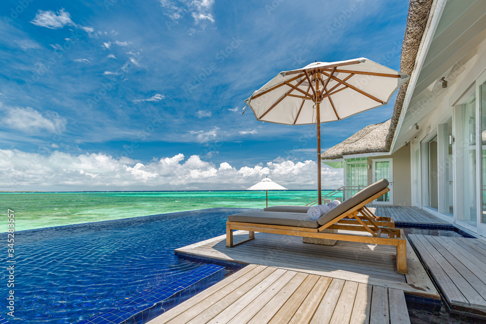 Luxury beach resort, water villa bungalow near endless pool over sea ...