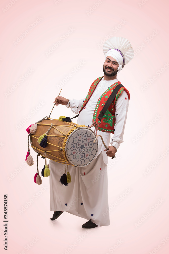 Sikh Man Playing On A Dhol Stock Photo | Adobe Stock