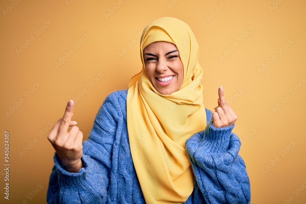 Young beautiful brunette muslim woman wearing arab hijab over isolated ...