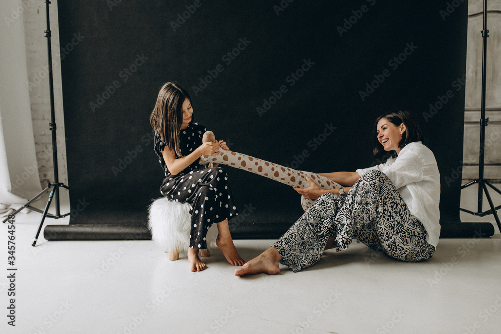 Vivacious and happy mother and daughter. They fool around and play fun ...