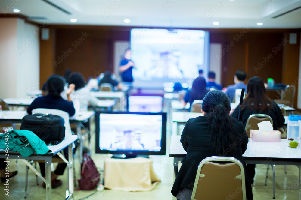 Stock-Foto „Selective focus to business woman with blurry speaker and ...