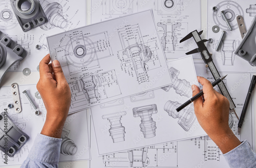 Engineer technician designing drawings mechanical parts engineering ...