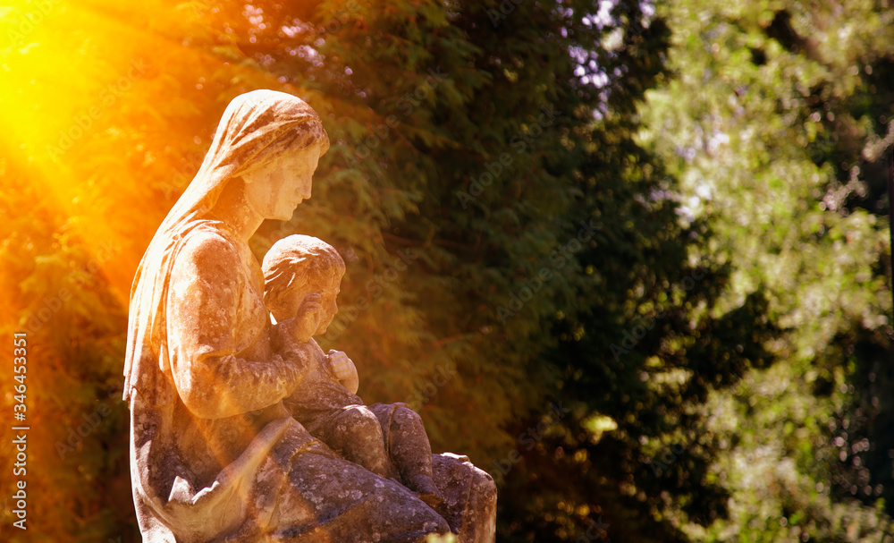 Fragment of ancient stone statue of Virgin Mary with the baby Jesus ...