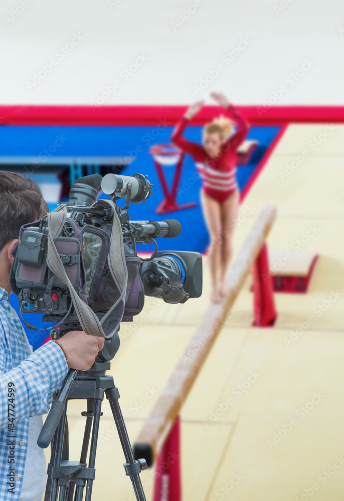Cameraman shooting live broadcast from gymnastics game to television ...