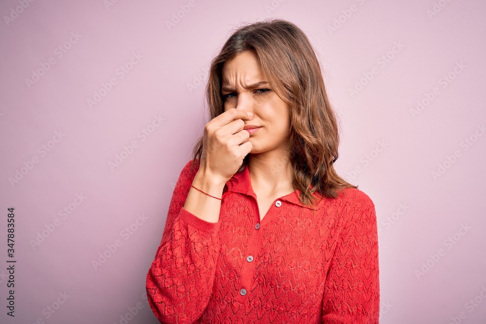 Young beautiful blonde casual girl over pink isolated background ...