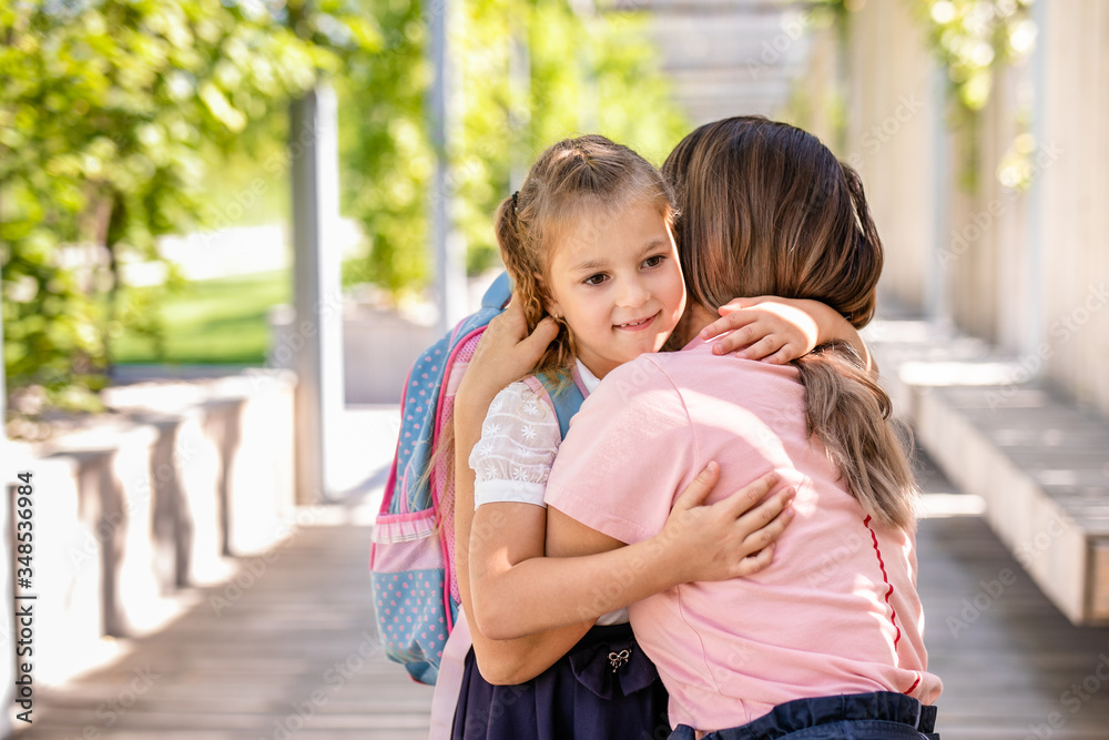 Parent mother taking child to school. Pupil girl of primary school go ...