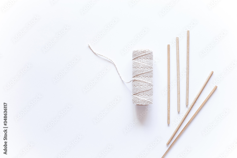 Tools and materials for macrame weaving over white surface. Cotton ...