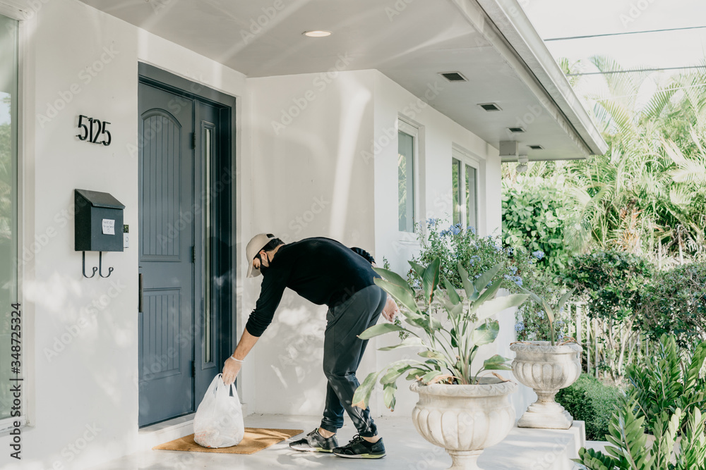 Food delivery man practicing social distance Stock Photo | Adobe Stock