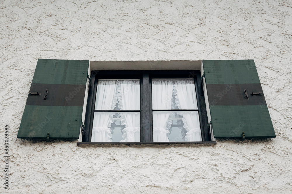Green and black striped shuttered window of a traditional Bavarian ...
