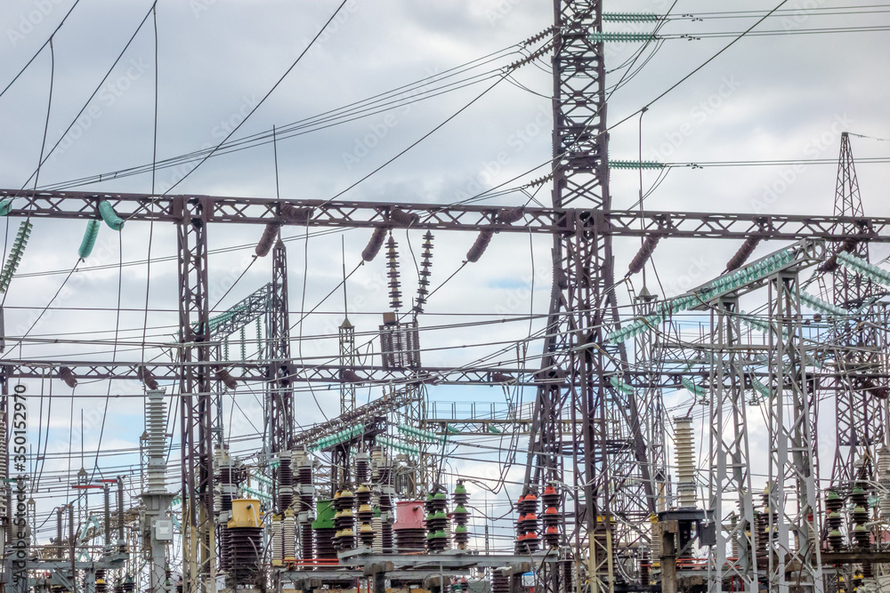 Metal towers, weaving wires and cables at a transformer electrical ...