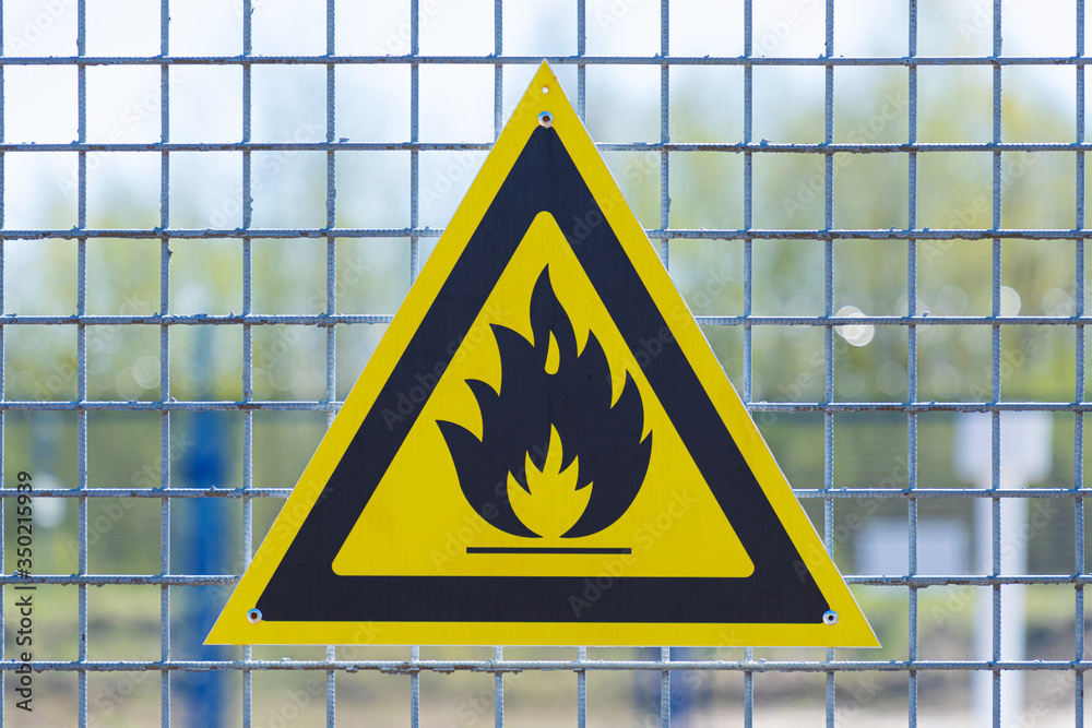 Black caution or warning fire triangle sign on yellow background or ...