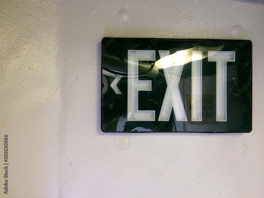 Black exit sign at emergency exit door background on USS Iowa naval ...