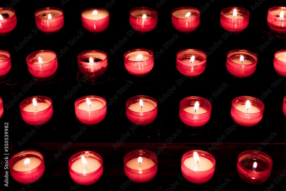 Group of red candles in church for faith resurrection prayer ...
