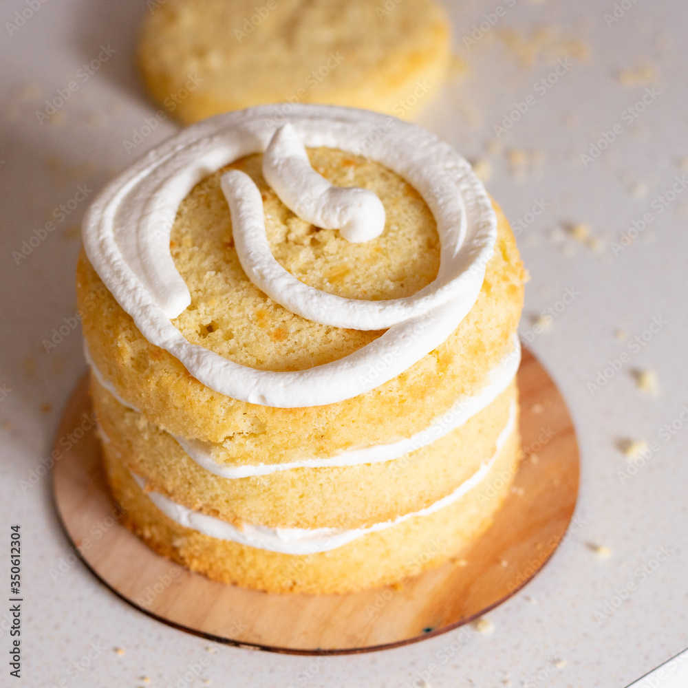 Applying the cream on the cake. Multi-layer homemade cake for a ...