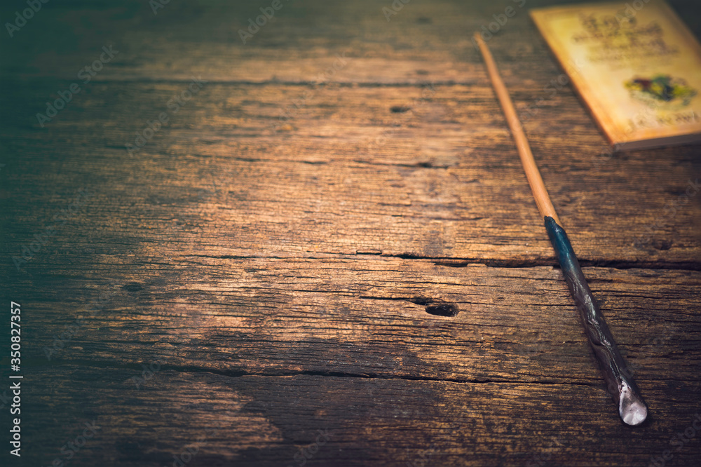 Magic wand on old wooden table. Stock Photo | Adobe Stock