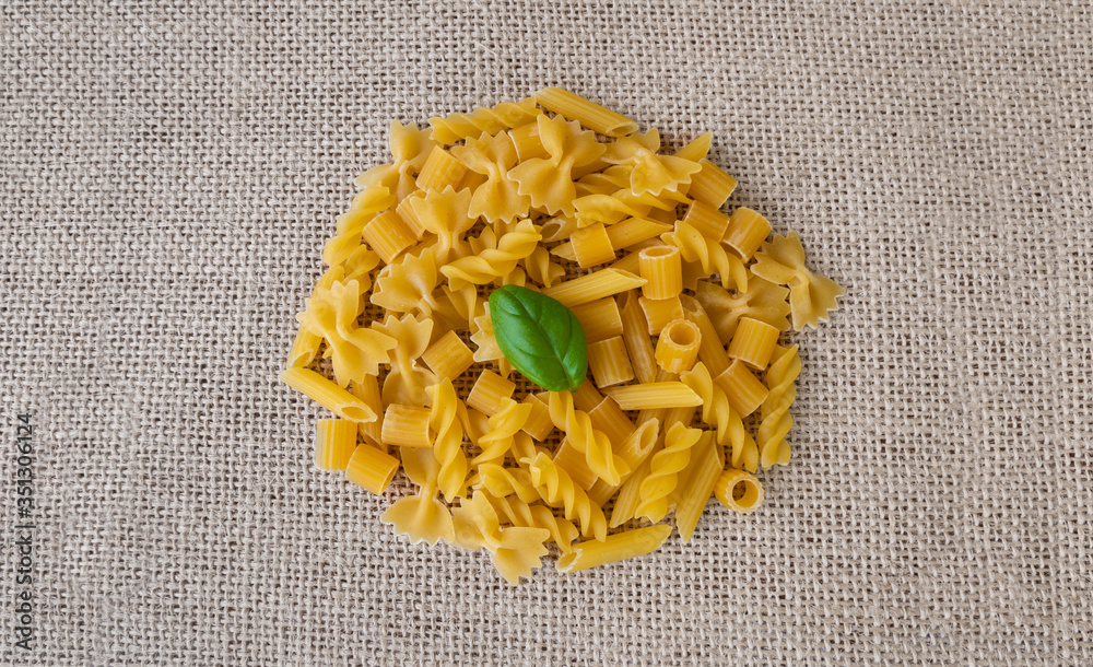 Varieties of raw pasta which include: farfalle, fusilli, ditaloni ...